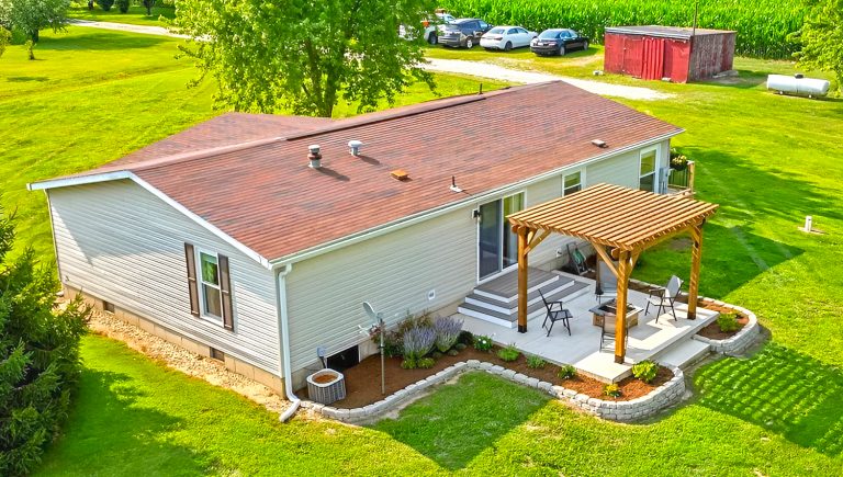 A Stylish Mobile Home Exterior with Front Deck and Back Patio