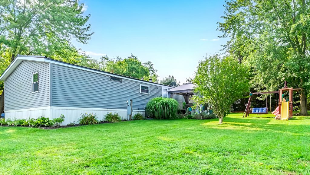 1987 Mobile Home Exterior with Wood Front Porch and Backyard